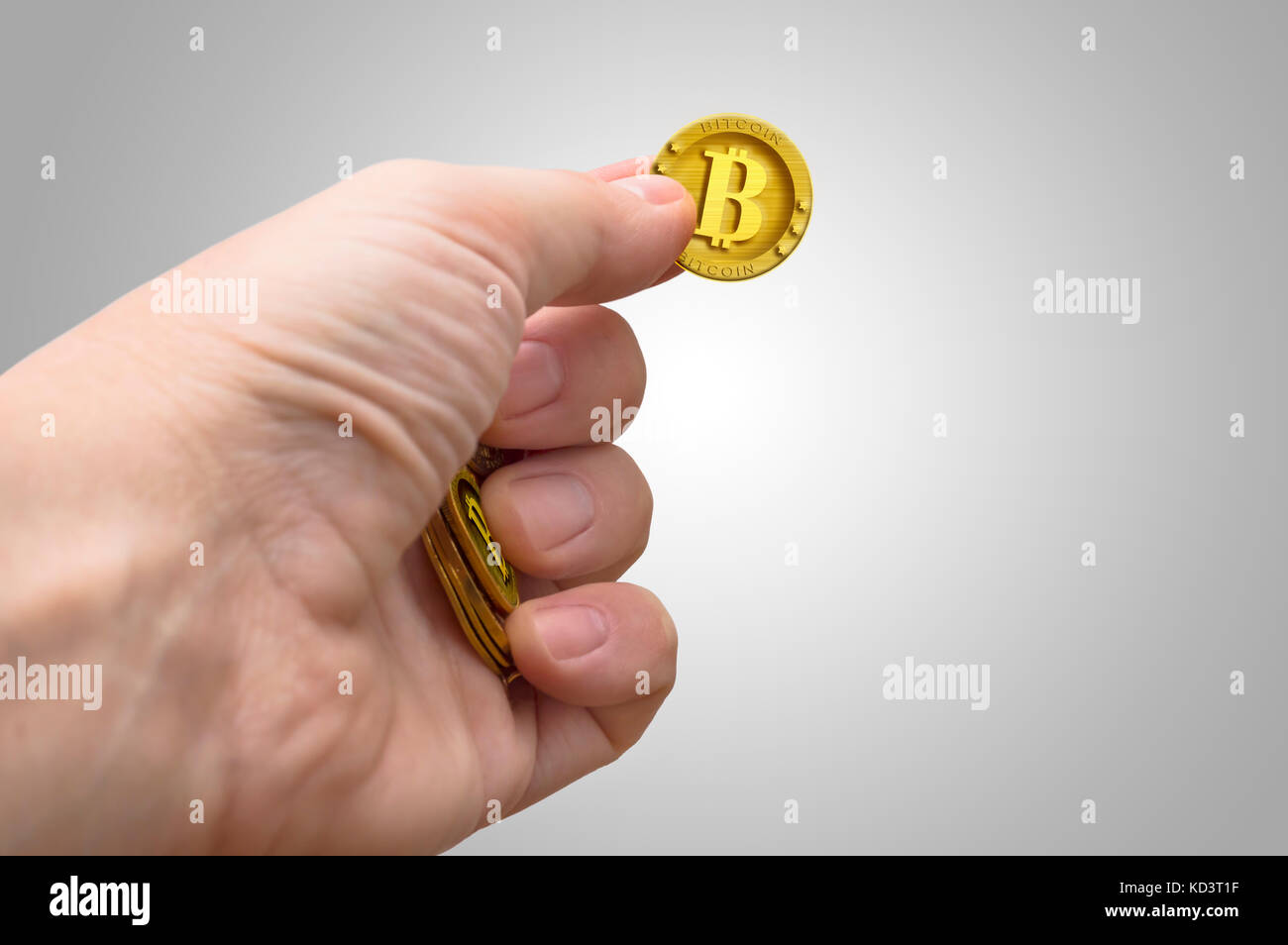 Close up of Golden Bitcoin in hand Stock Photo - Alamy
