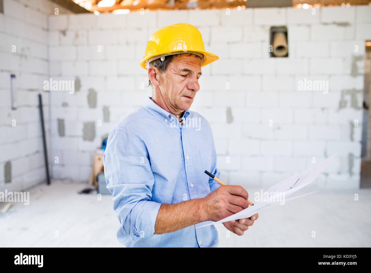 Senior architect or civil engineer at the construction site with ...