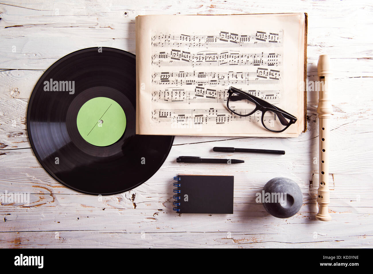 Desk with music school supplies. Studio shot on white wooden background ...