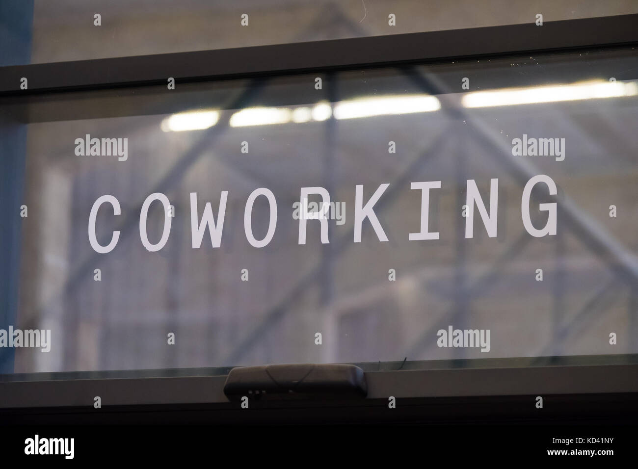 Coworking logo in the modern interior Stock Photo - Alamy