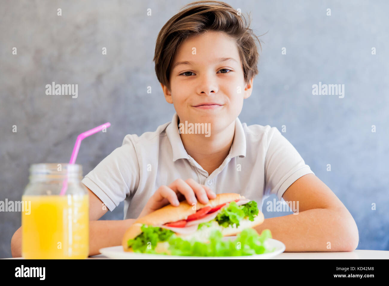 Portrait of cute teen boy having breakfast at home Stock Photo - Alamy