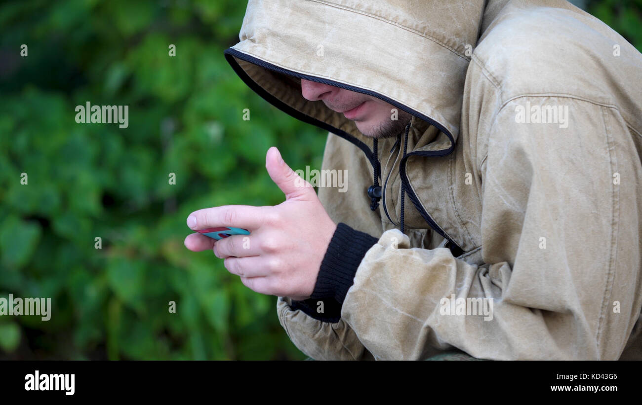 Busy young environmentalist is working on the phone in the woods. Young ...