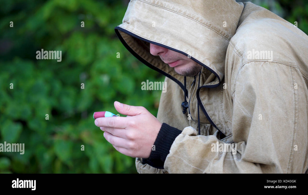 Busy young environmentalist is working on the phone in the woods. Young ...