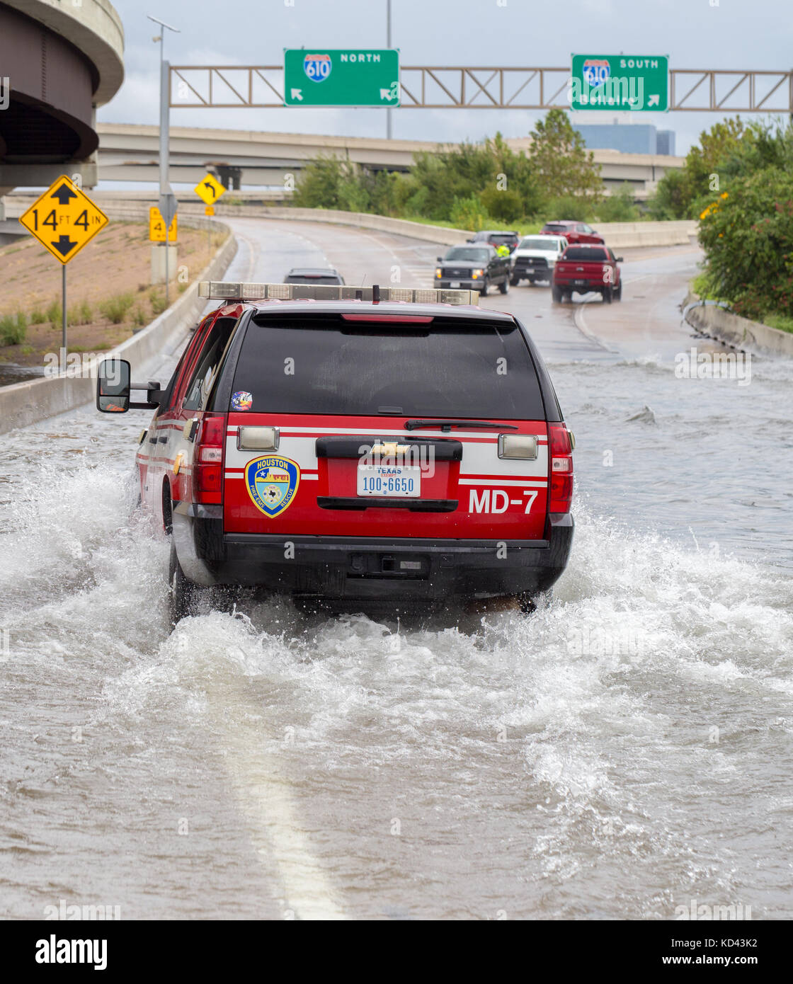 A city of Houston emergency vehicle pushes through floodwaters from ...