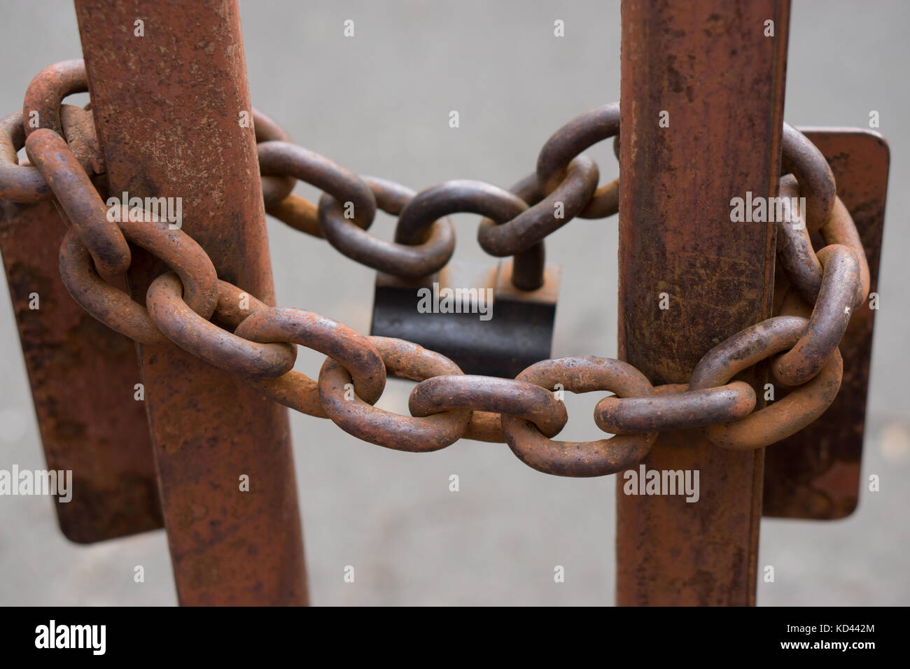 closeup of closed gates with massive metal steel rusty chains with big ...