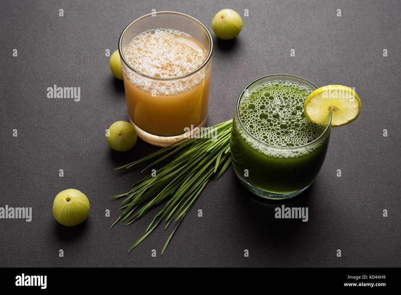 Ayurvedic or medicinal Wheat grass juice with lemon slice and Amla ...