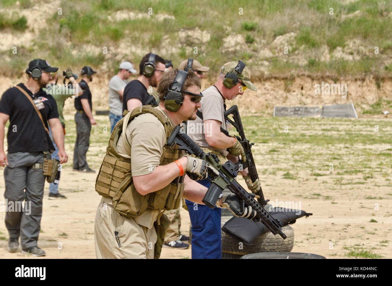 Men shooting outdoors Stock Photo - Alamy