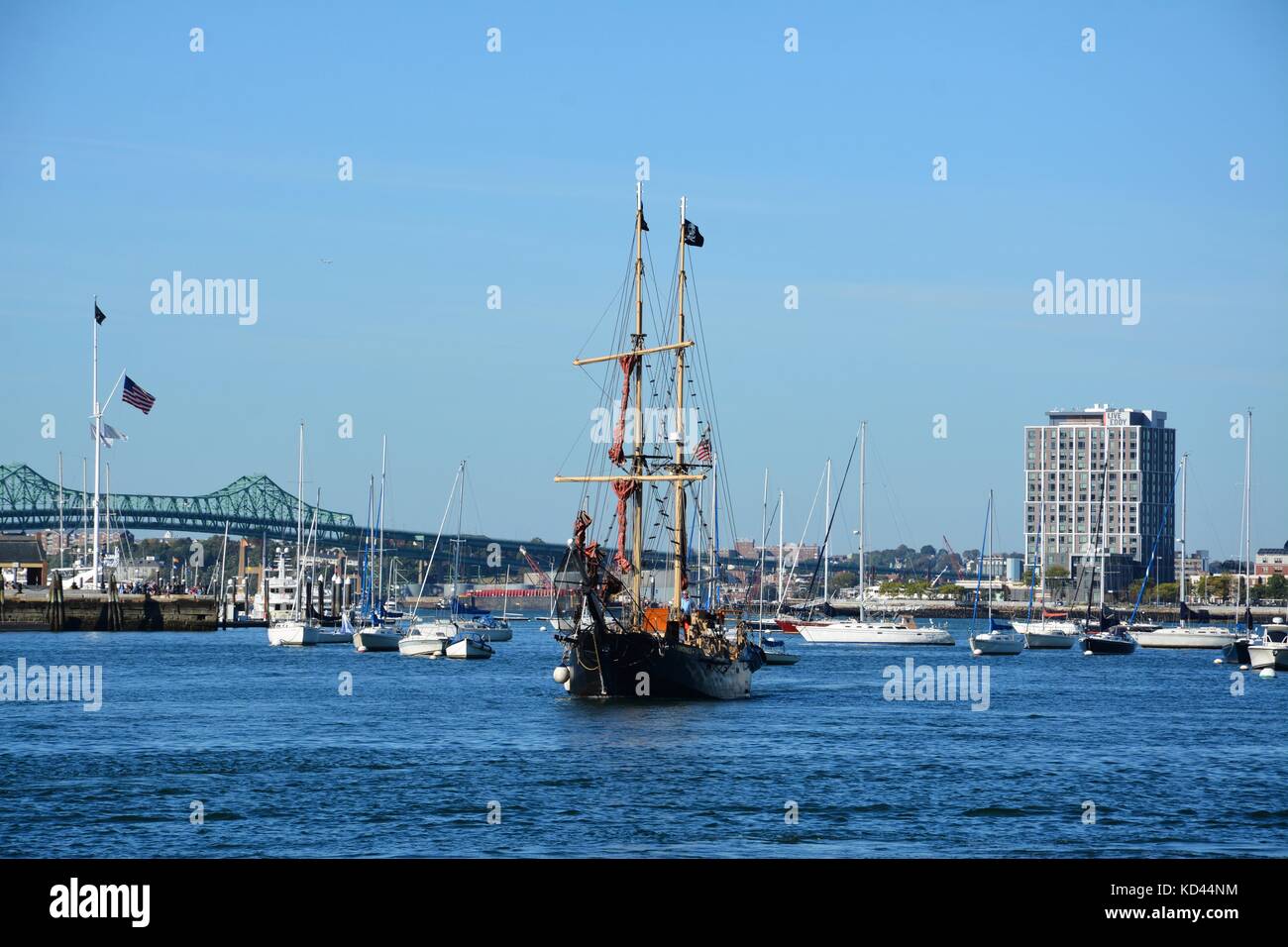 A tall ship in Boston Harbor near the Seaport/Downtown Boston Stock ...