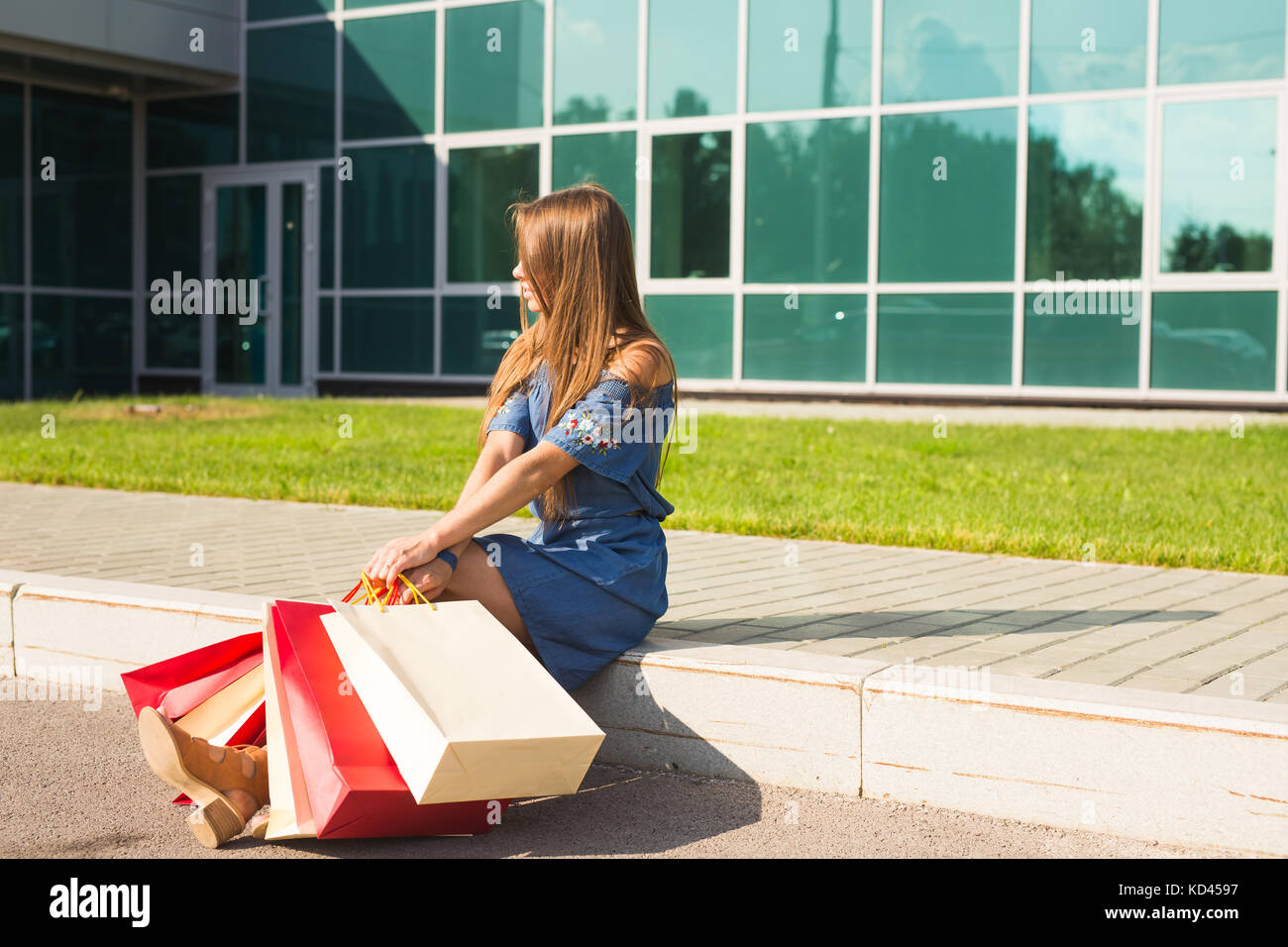 After day shopping. Close-up of young woman carrying shopping bags ...