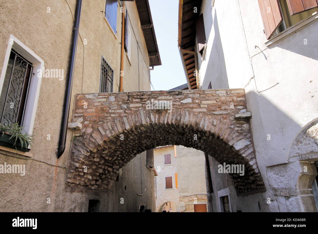 architectural detail of a small bridge between two ancient houses in a ...