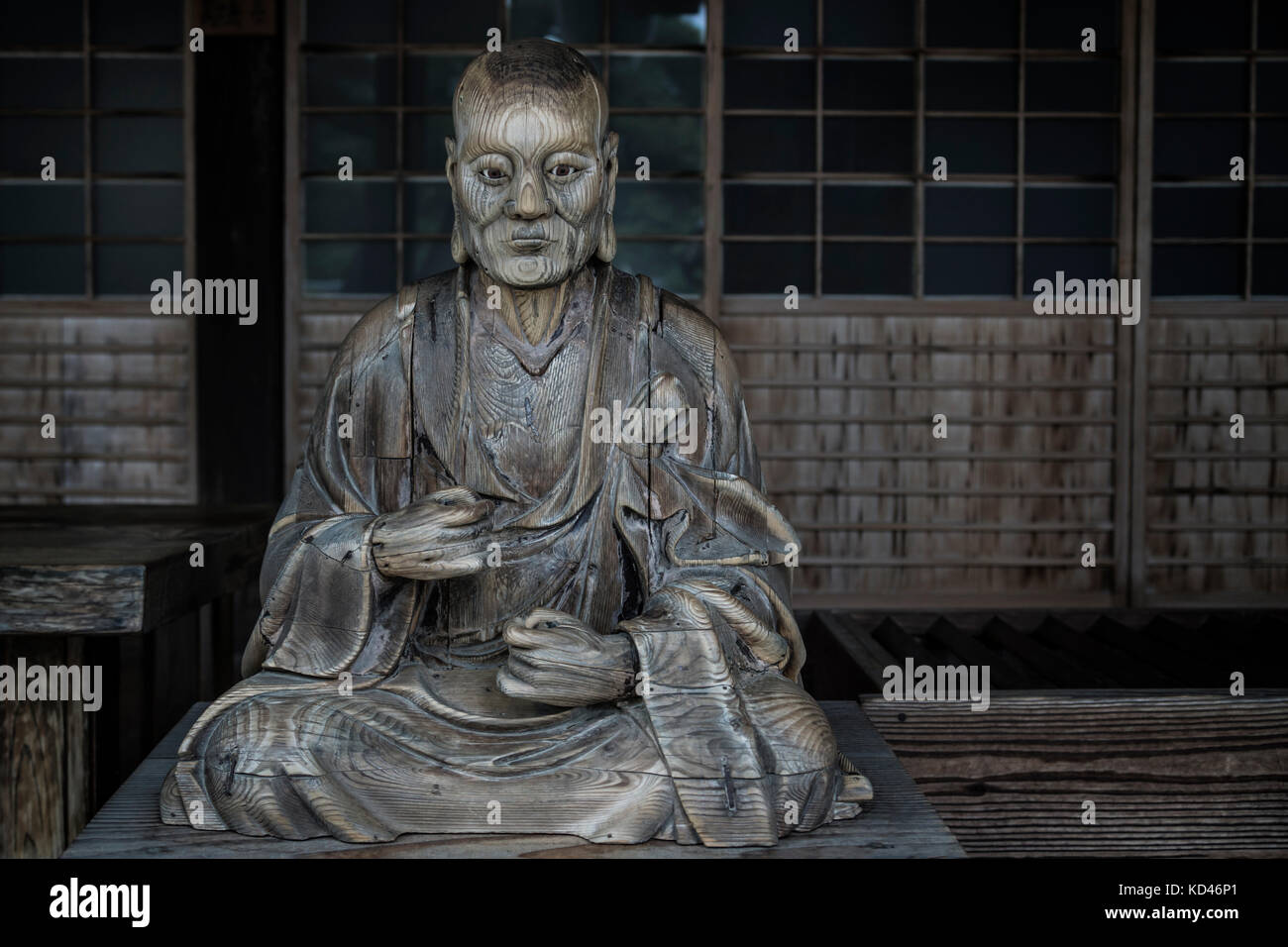 Wooden statue of a monk at wooden shrine, Miyajima, Japan Stock Photo ...