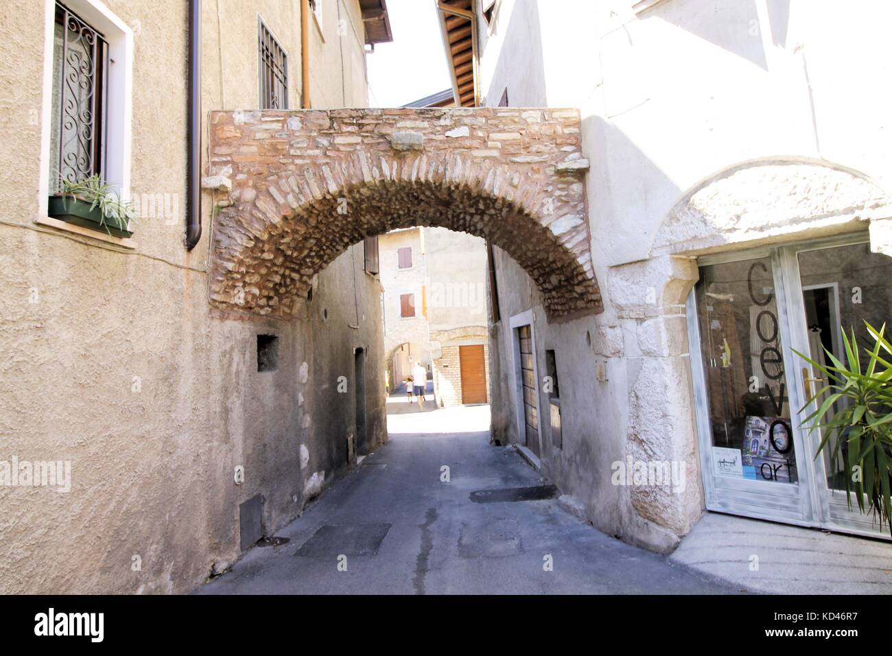 architectural detail of a small bridge between two ancient houses in a ...