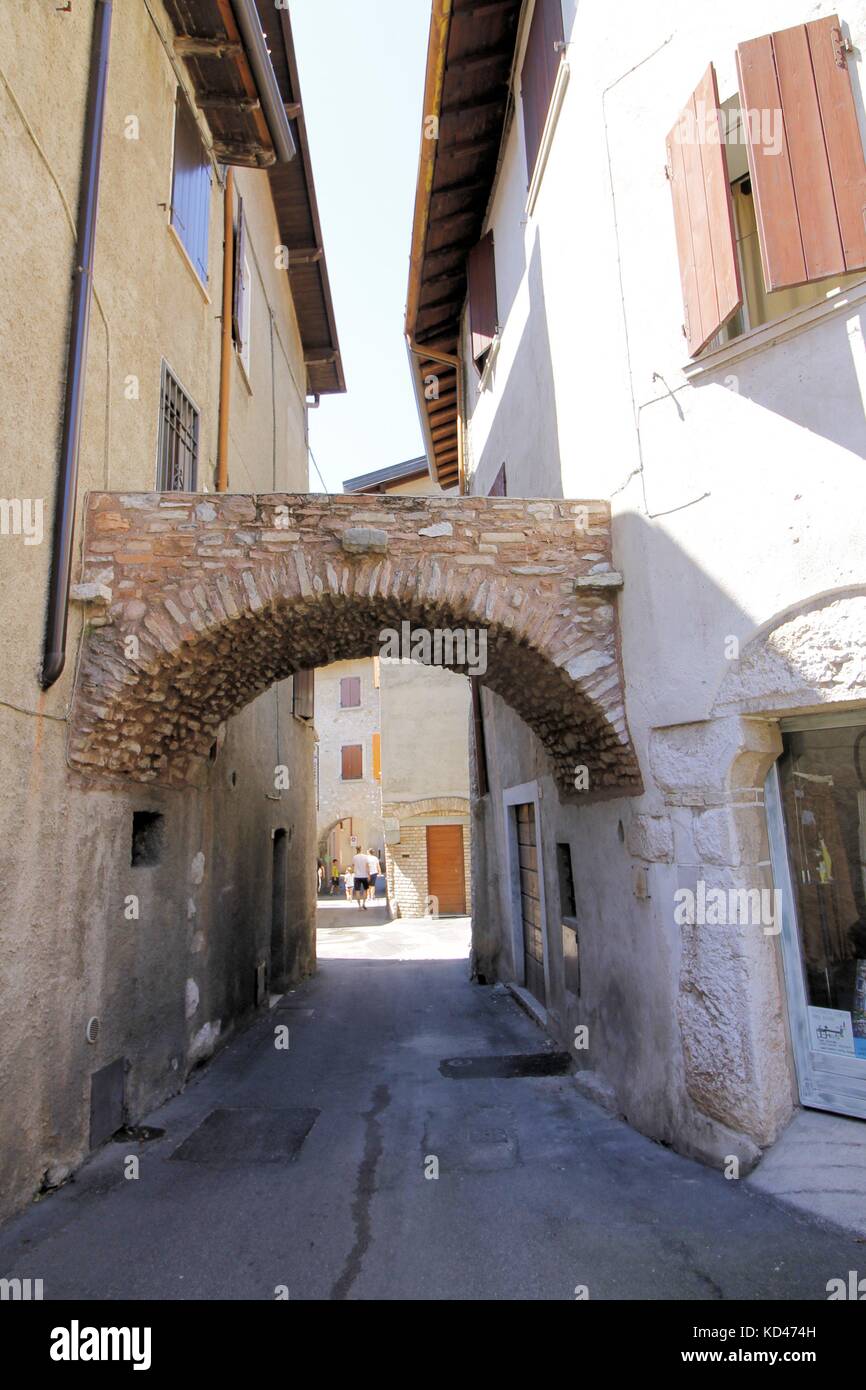 architectural detail of a small bridge between two ancient houses in a ...