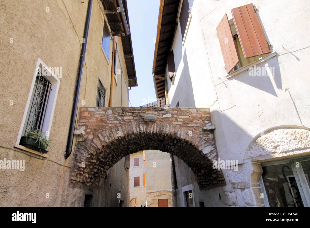 architectural detail of a small bridge between two ancient houses in a ...