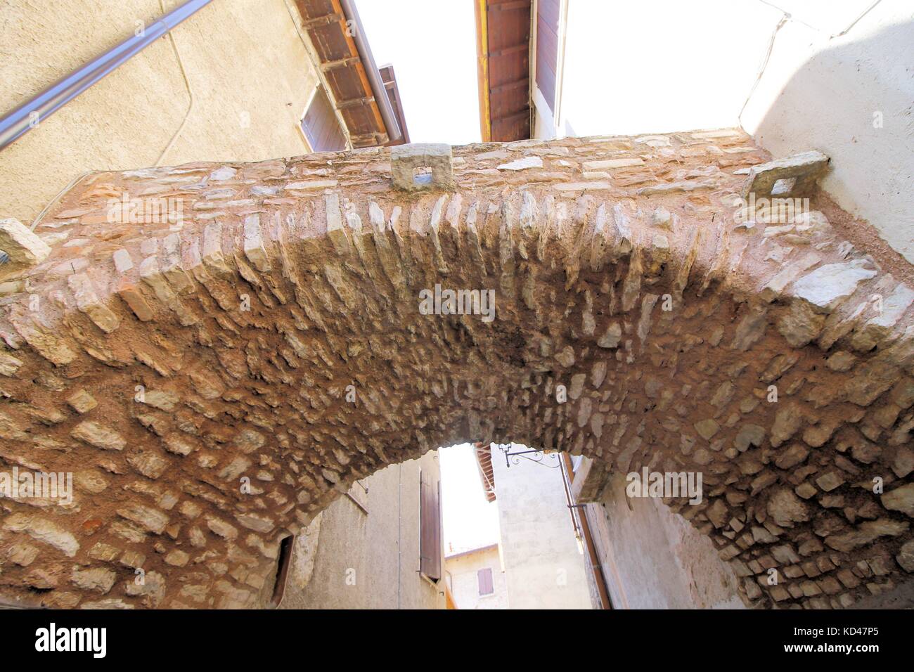 architectural detail of a small bridge between two ancient houses in a ...