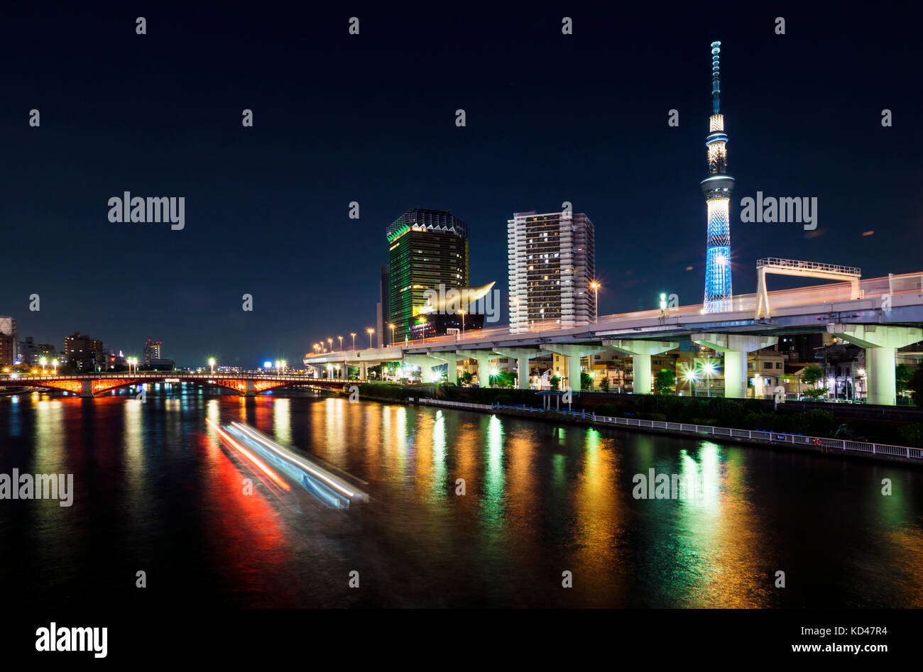Skyline of Tokyo with skytree and river and boat at night, Tokyo, Japan ...
