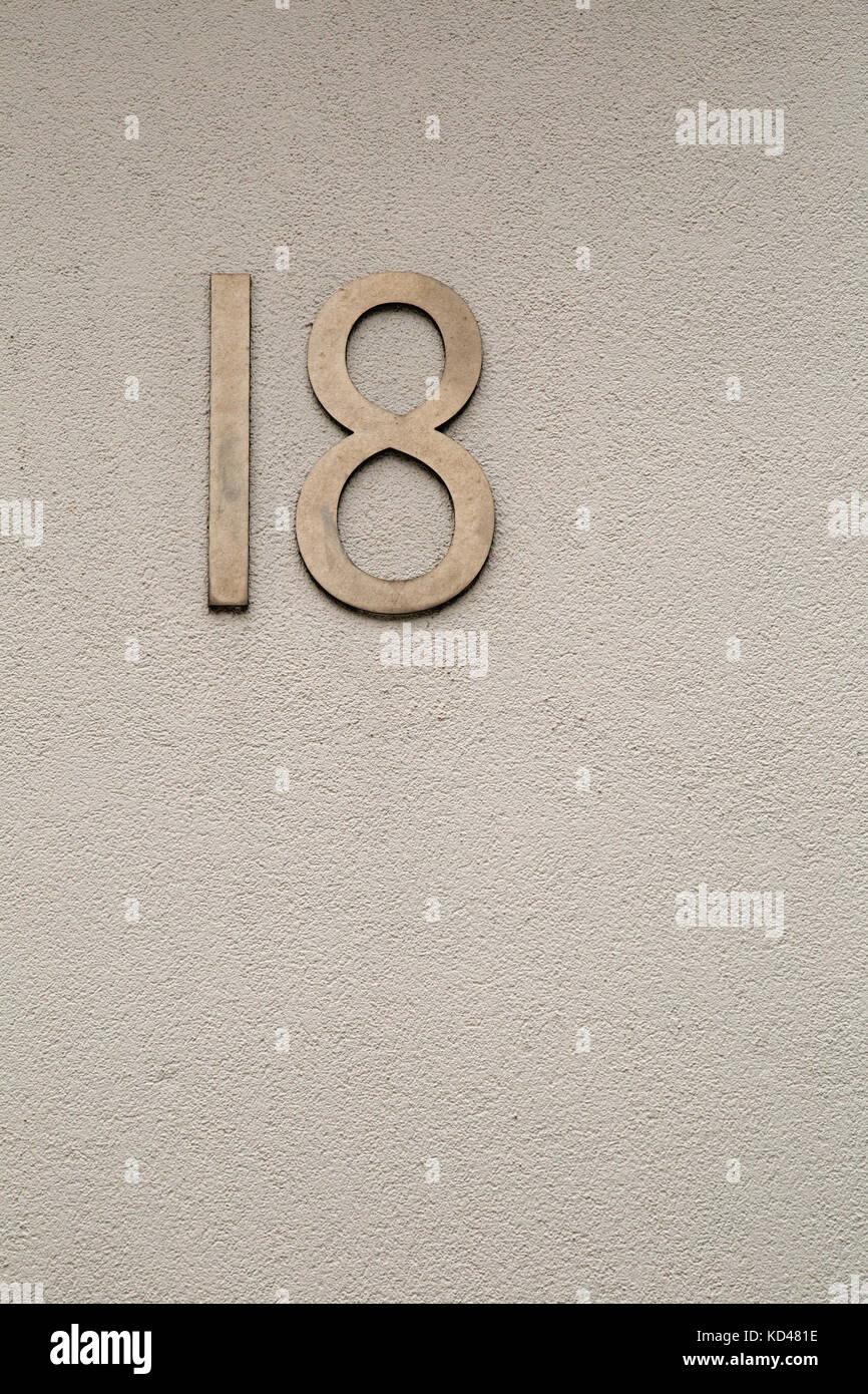 Arabic numbers reading 18 on a off white background Stock Photo - Alamy
