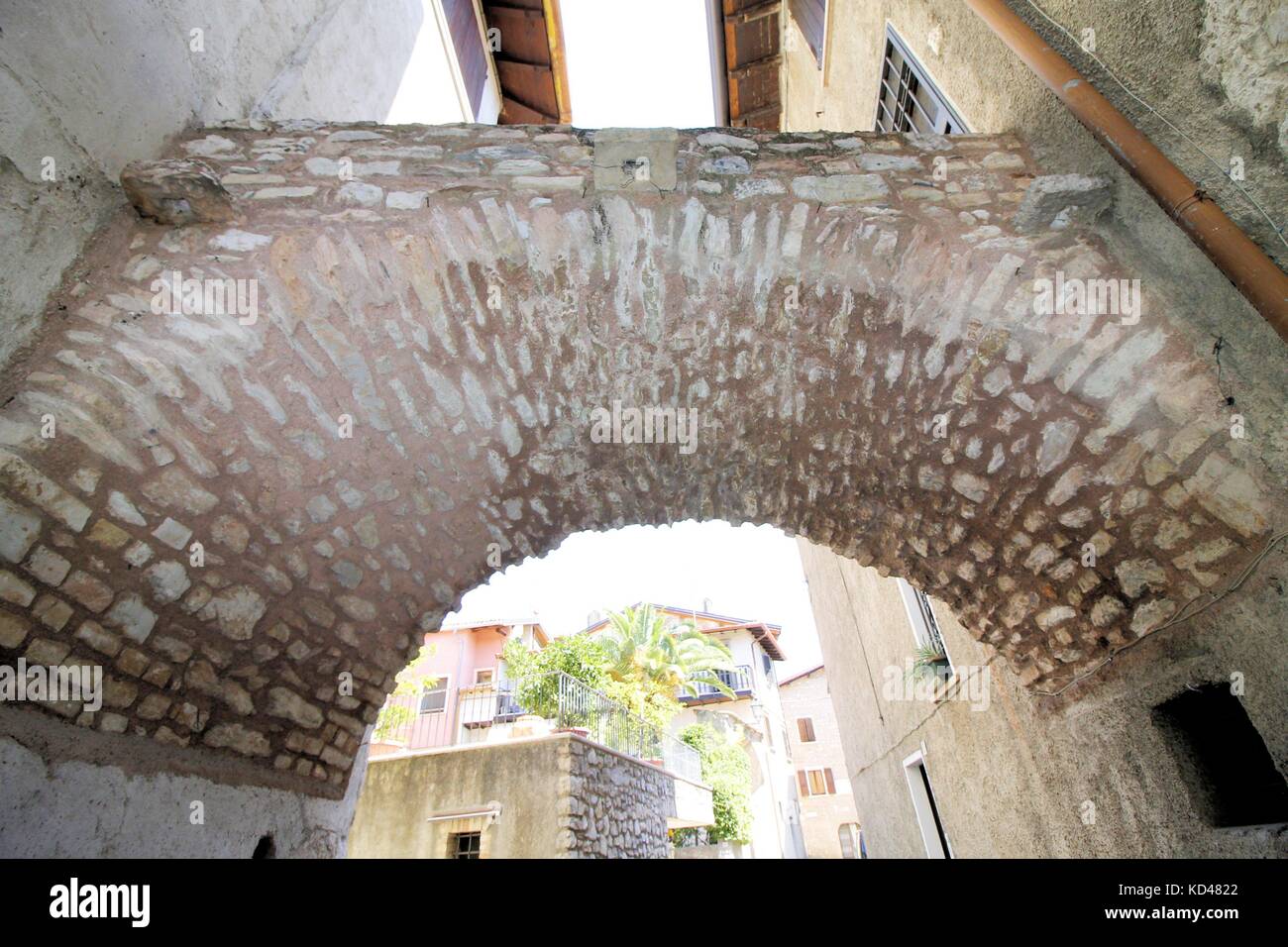 architectural detail of a small bridge between two ancient houses in a ...