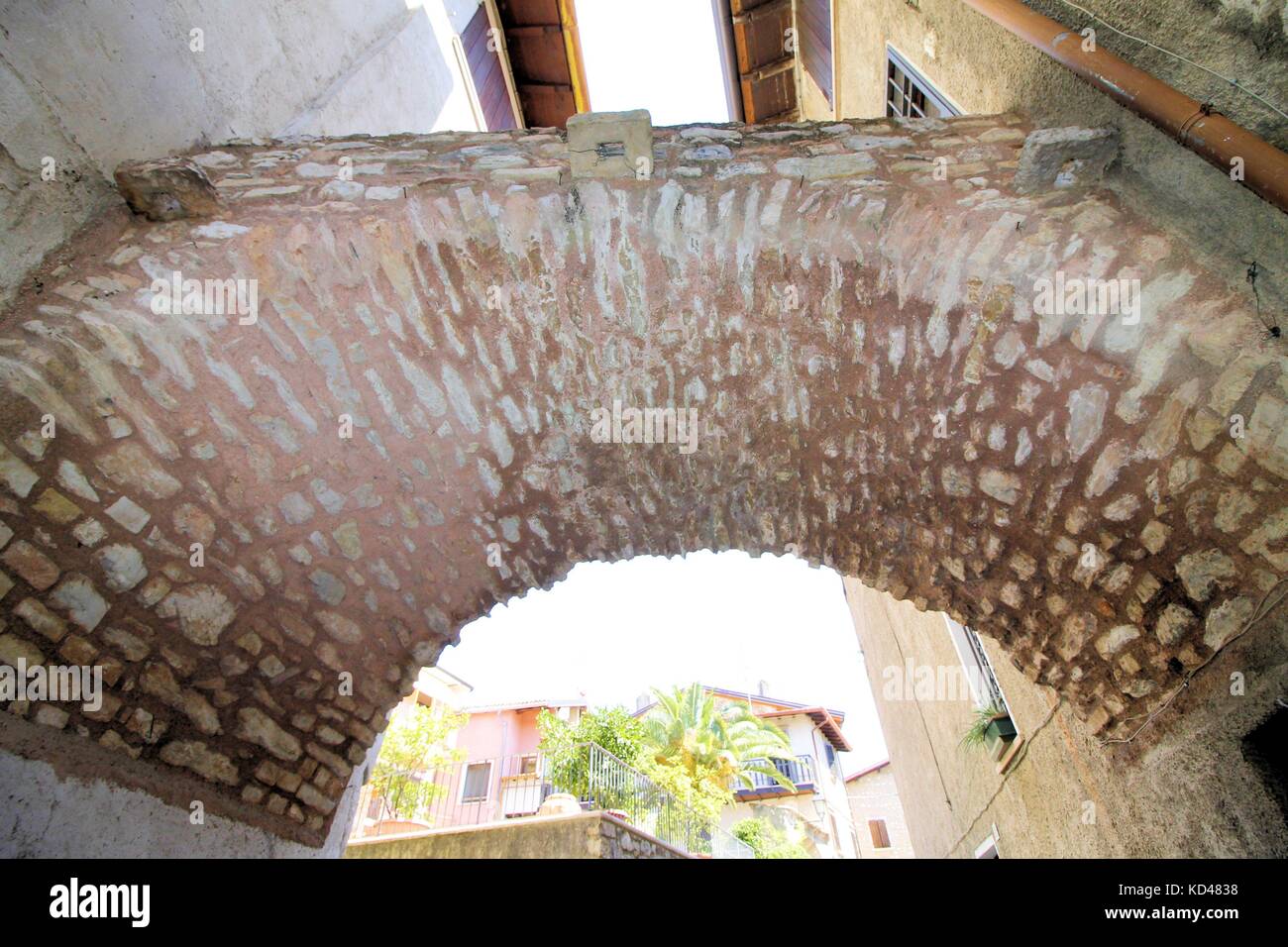 architectural detail of a small bridge between two ancient houses in a ...