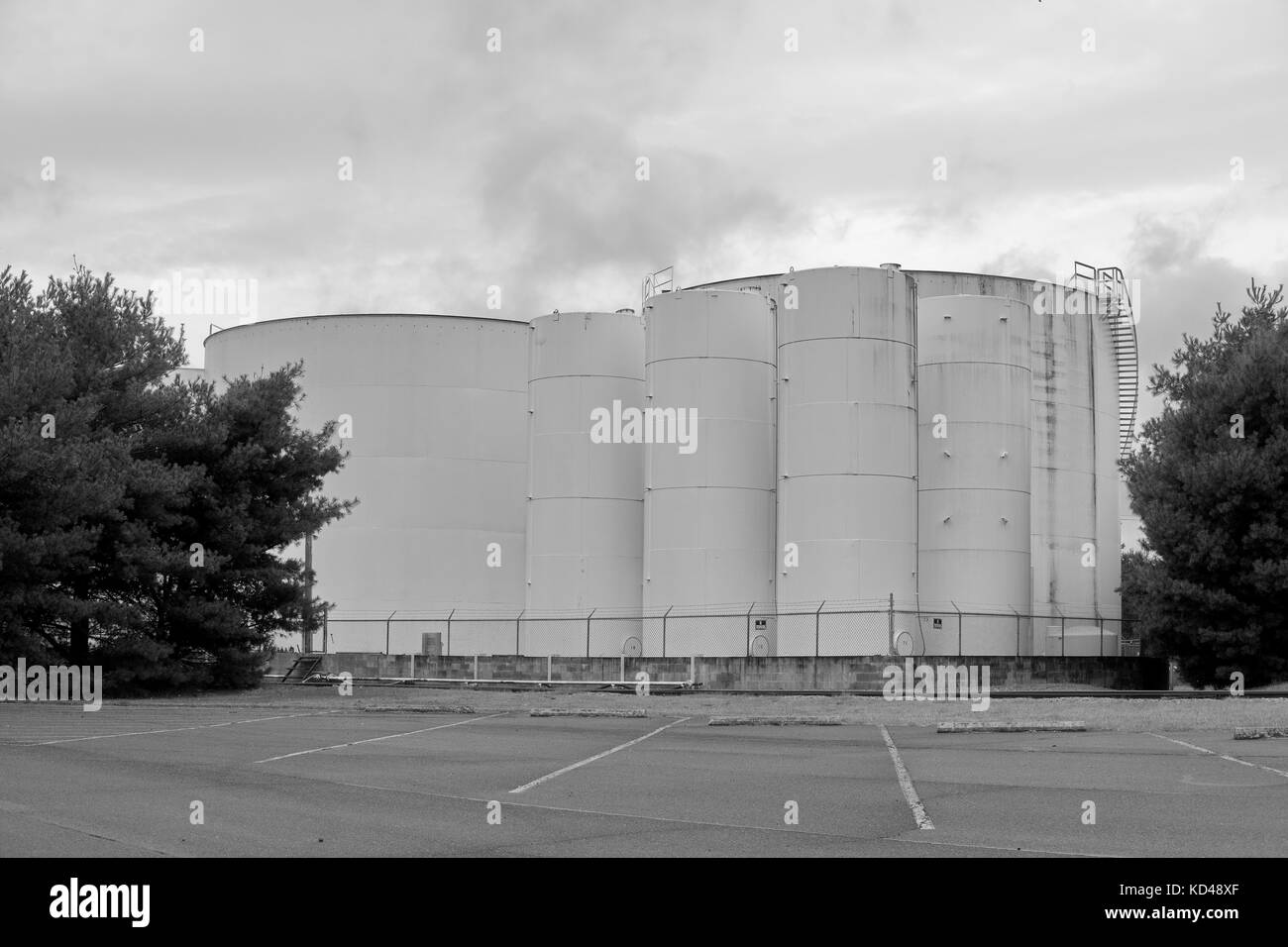 Chemical storage tanks painted white - in black & white Stock Photo - Alamy