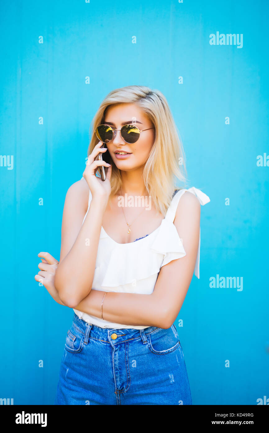 Pretty Woman Calling Someone Through Mobile Phone While Smiling at the ...