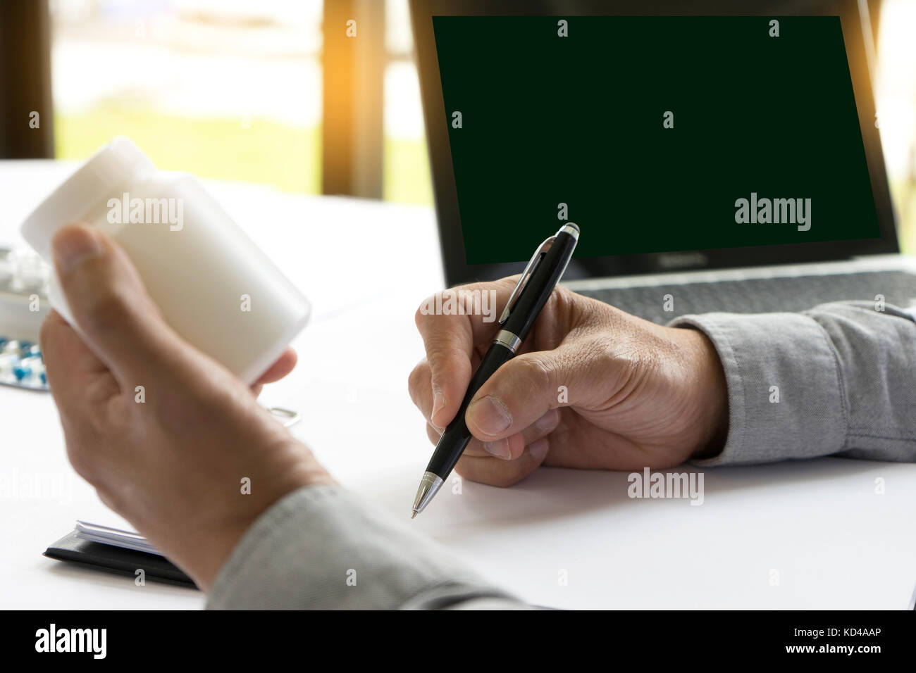 Doctor write prescription for take care to the patient with computer ...