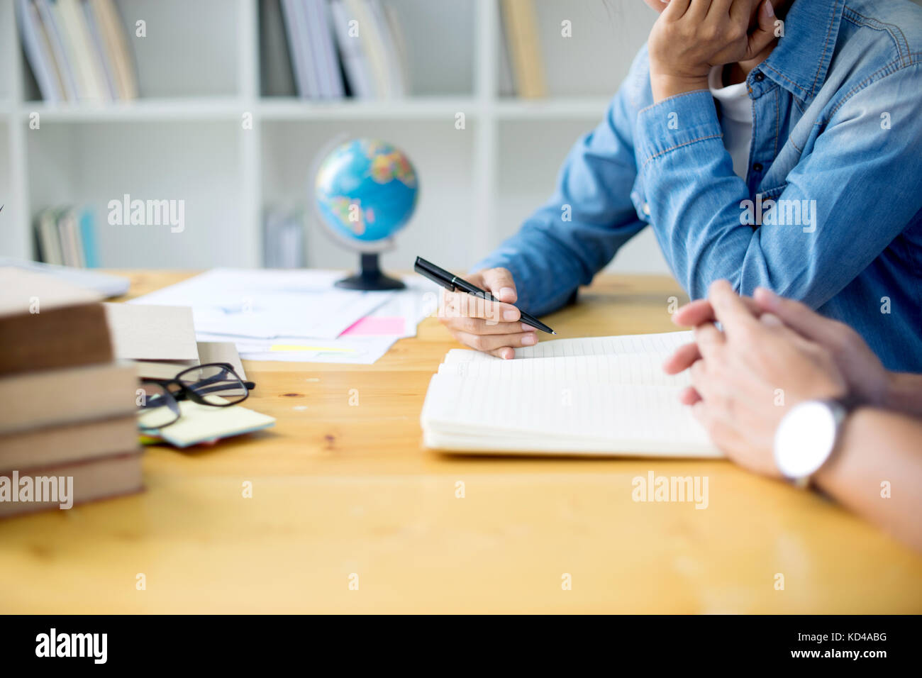 student work in the Library on the wood table Stock Photo - Alamy