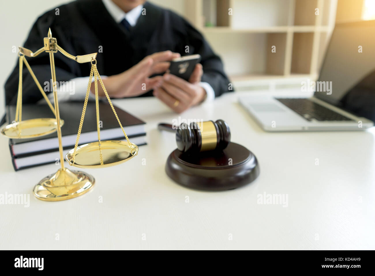 Judge use computer mobile phone in the office with Scales gavel hammer ...