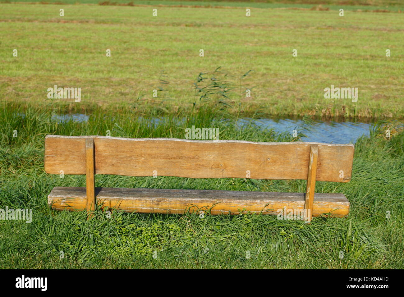 Wooden Seat Bench on a Meadow Stock Photo - Alamy