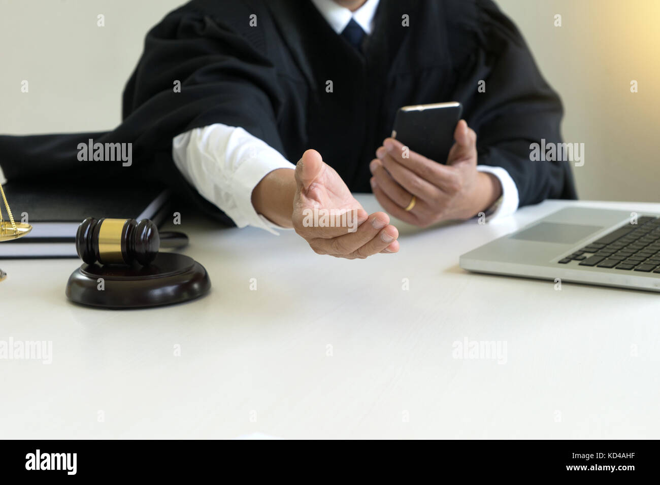 Judge use computer mobile phone in the office with Scales gavel hammer ...
