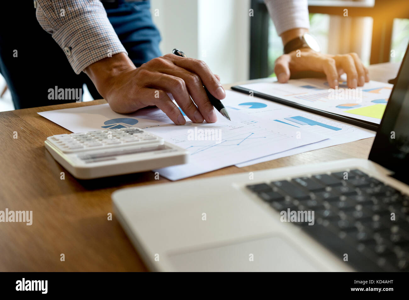 Businessman standing work on wood table prepare and read graph and ...