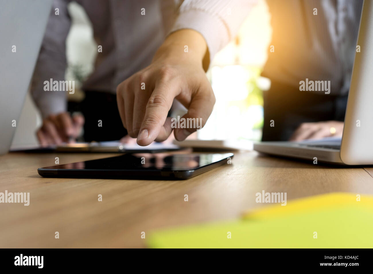 Two businessman working use computer and analysis paper graph on table ...