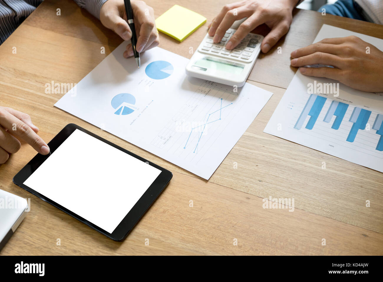 Two businessman working use computer and analysis paper graph on table ...