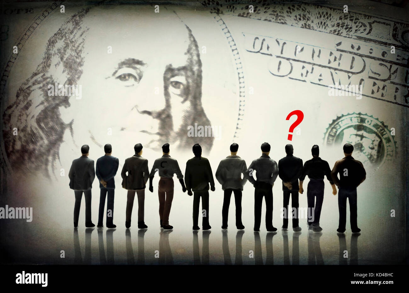 Silhouettes of figures of undecided people in front of a dollar bill ...