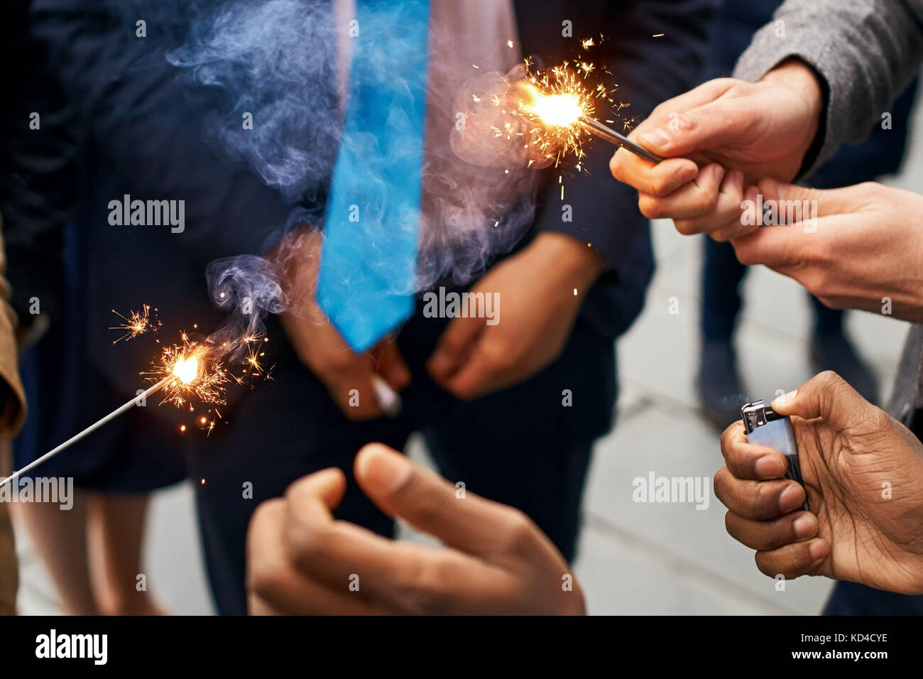 Hands of young people in suits holding burning sparkles fireworks Stock ...