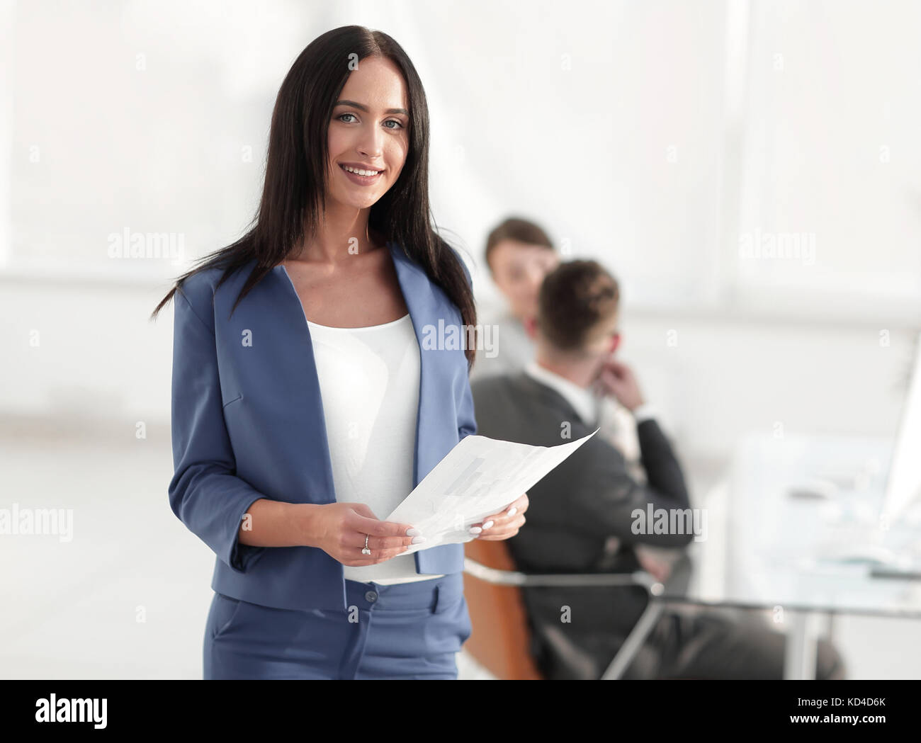 Beautiful woman on the background of business people Stock Photo - Alamy