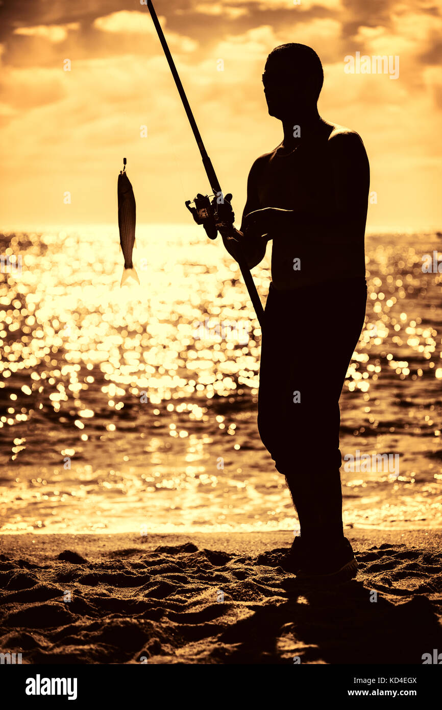Fishermen on the beach. Sunrise shot Stock Photo - Alamy