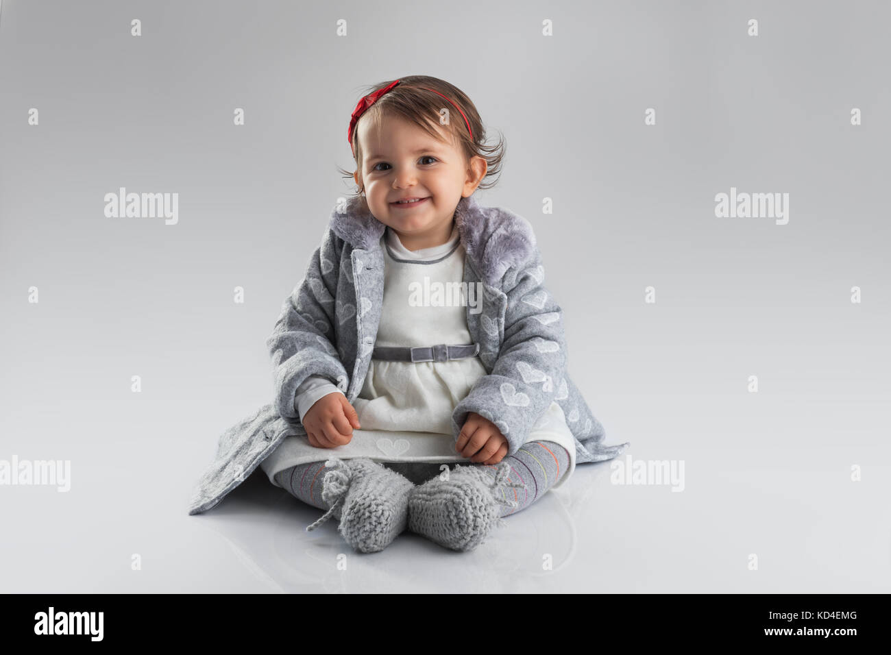 Portrait of a baby girl on a grey background Stock Photo - Alamy