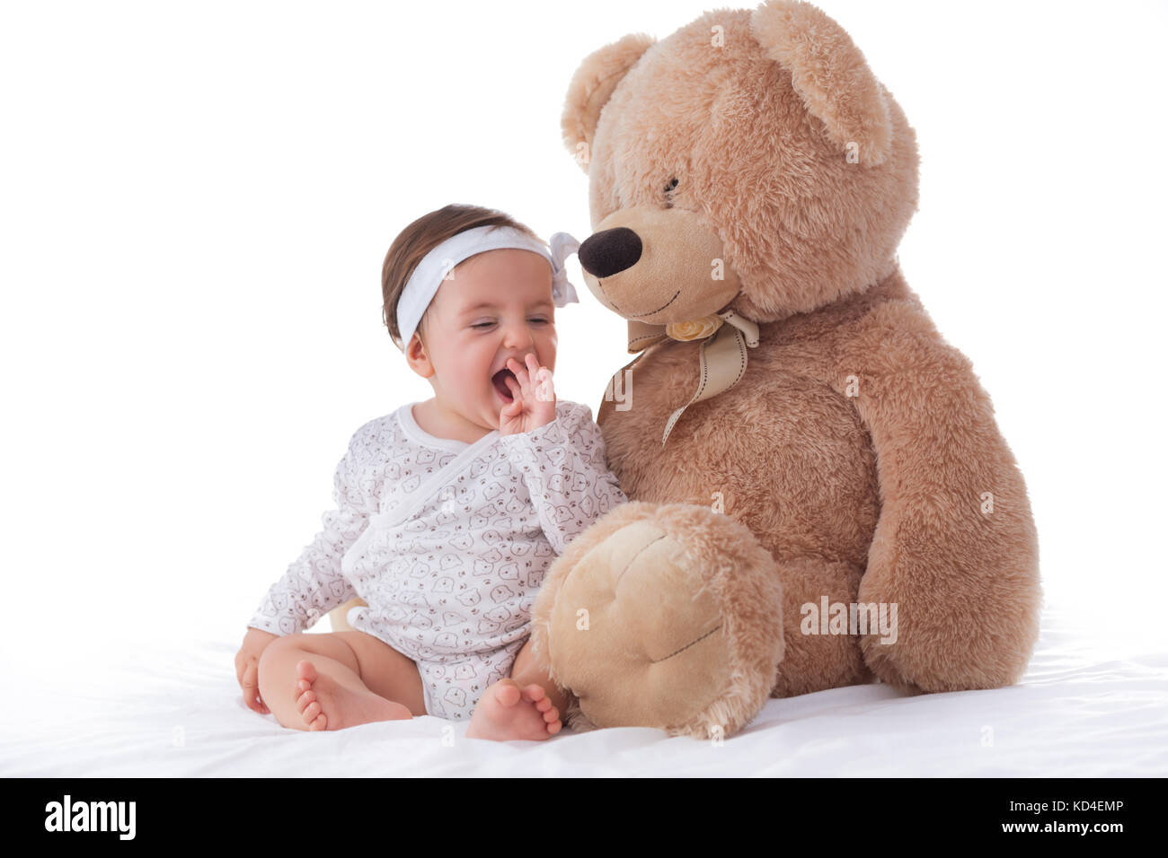 Happy baby girl playing with fluffy teddy bear isolated on white ...