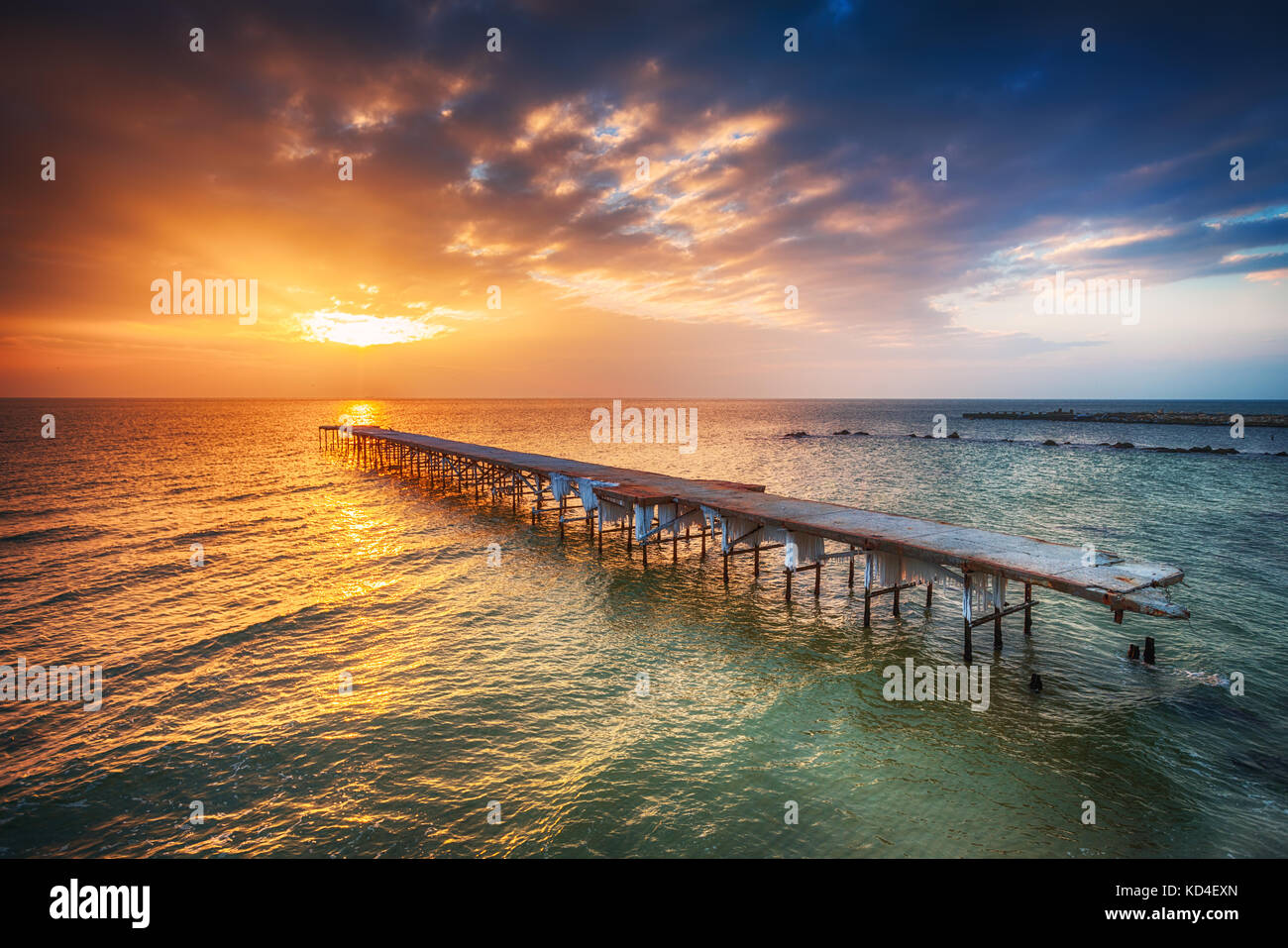 Old broken bridge in the sea, long exposure sunrise shot Stock Photo ...