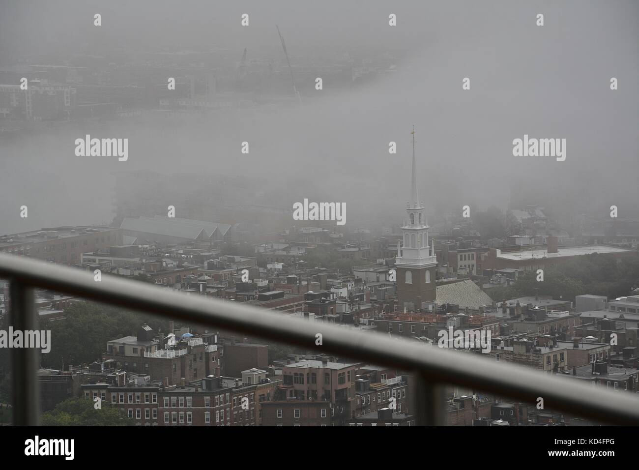 Downtown Boston under a low hanging cloud of fog rolling in off of ...