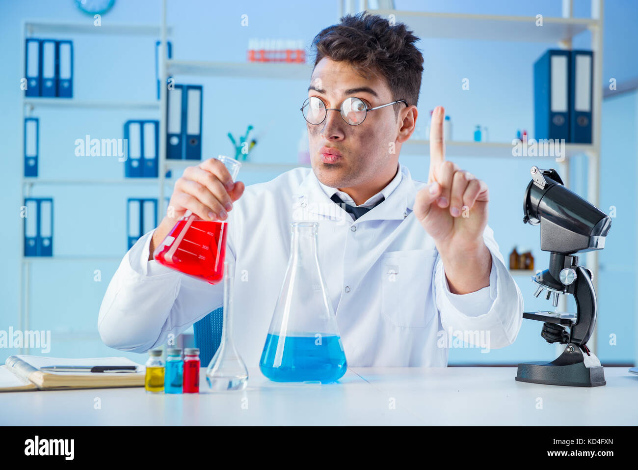 Funny mad chemist working in a laboratory Stock Photo - Alamy