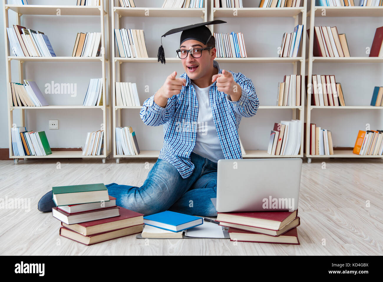 Young student studying with books Stock Photo - Alamy