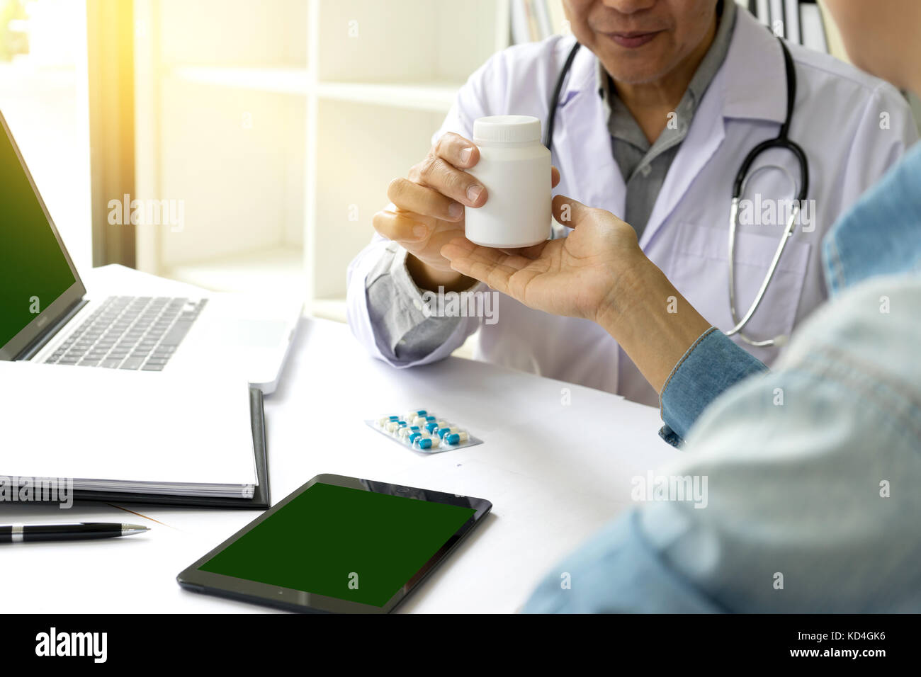 Doctor take care and give consult to the patient with tablet screen ...