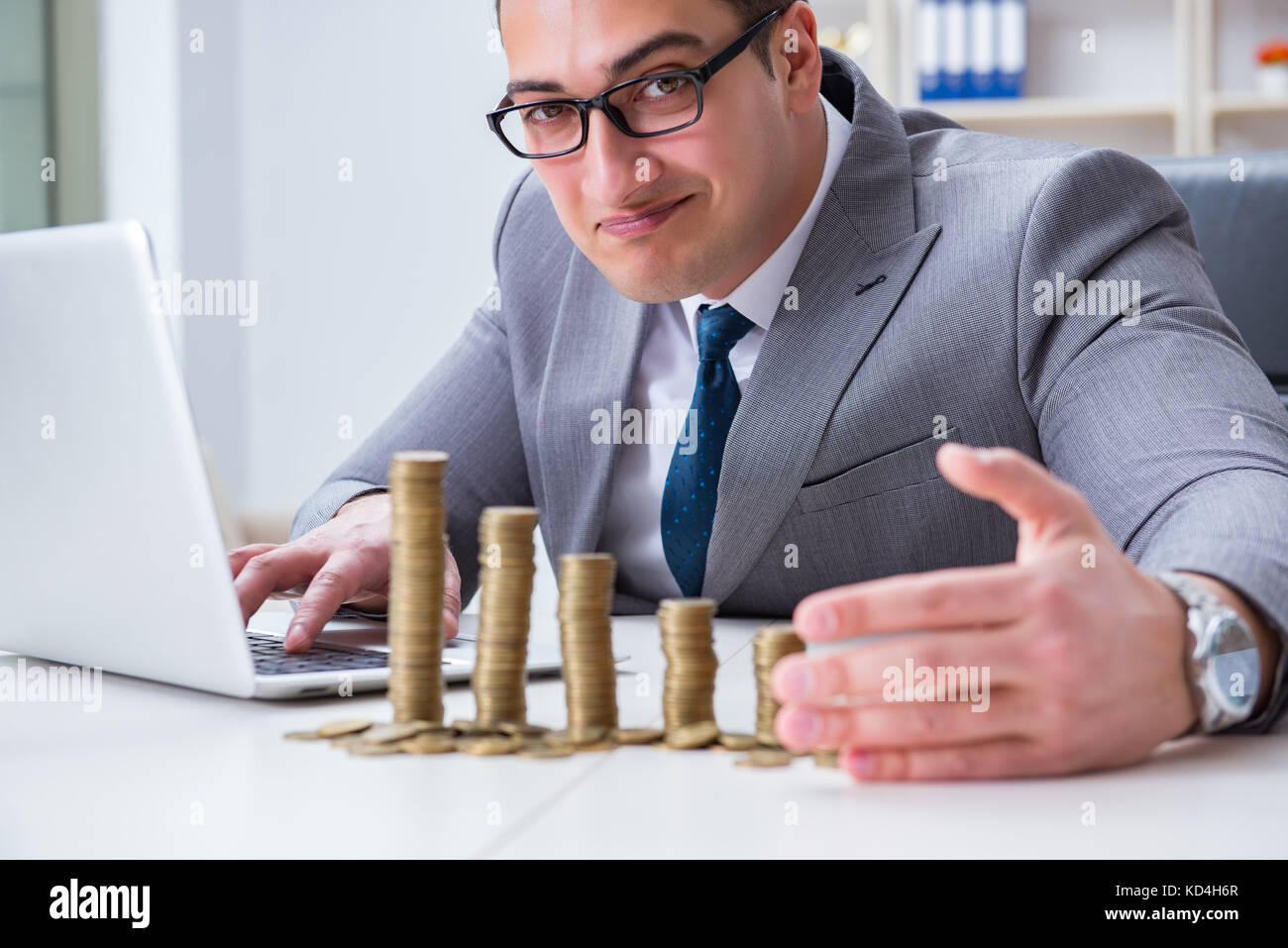 Man with coins in the office Stock Photo - Alamy