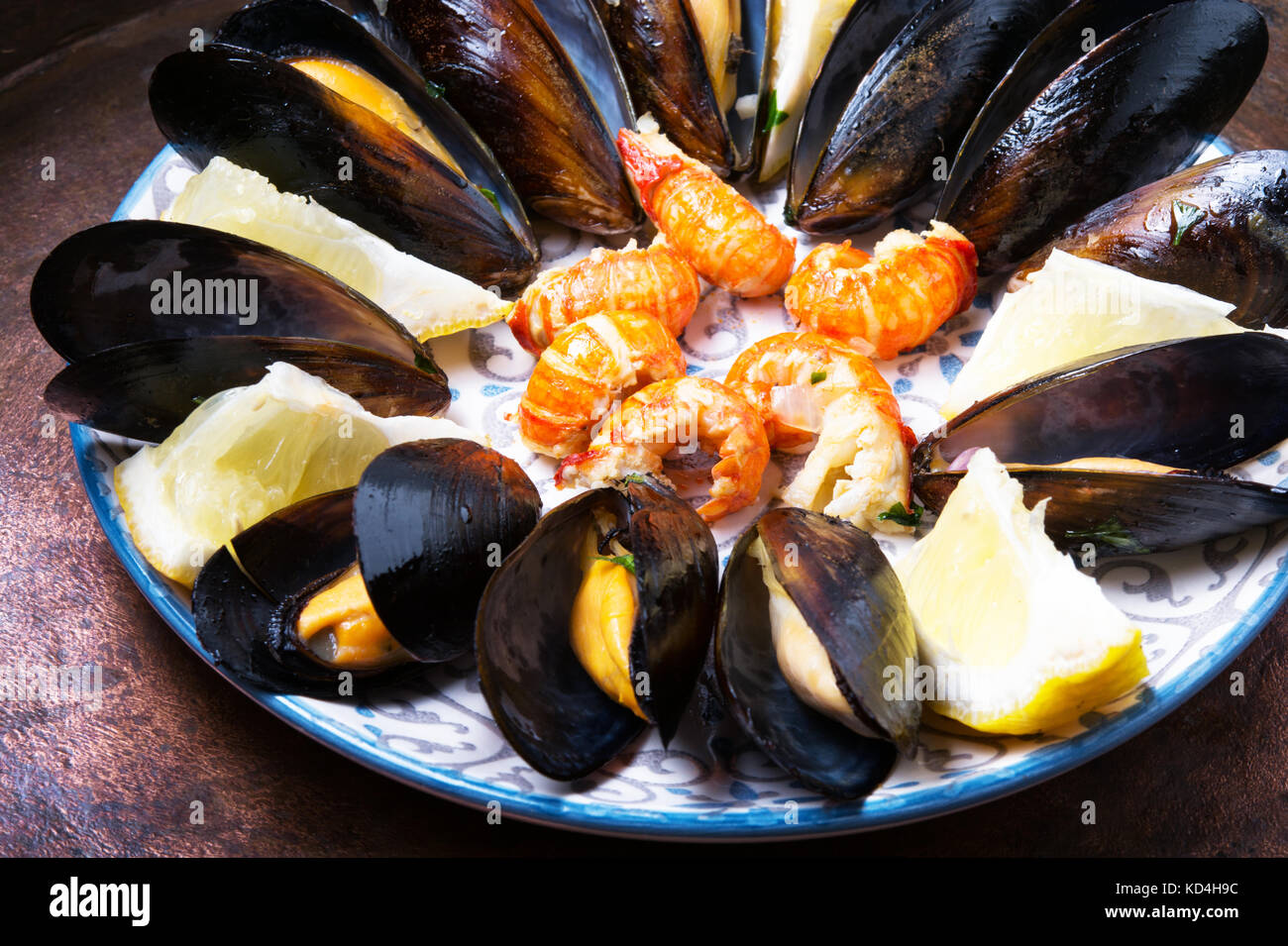 appetizer shellfish musselsin shell with lemon on retro background ...