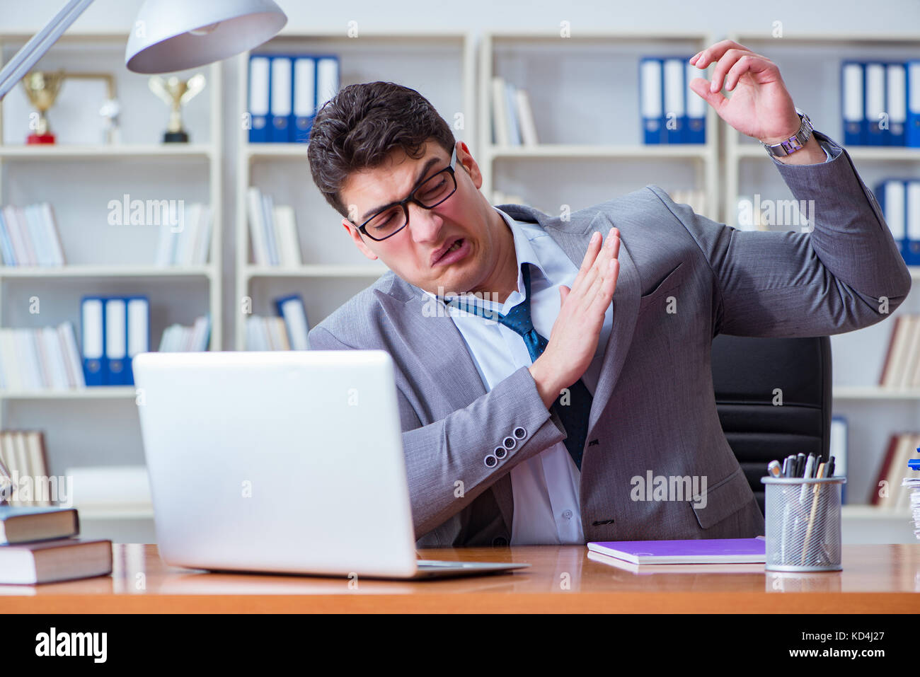 Businessman sweating excessively smelling bad in office at workplace ...