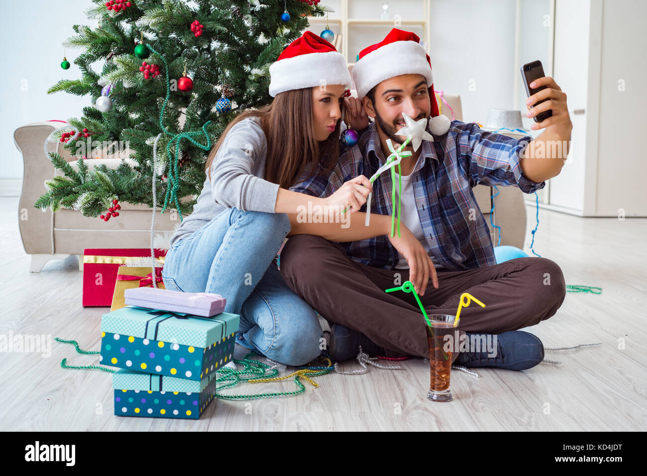 Young pair taking selfies during christmas Stock Photo - Alamy