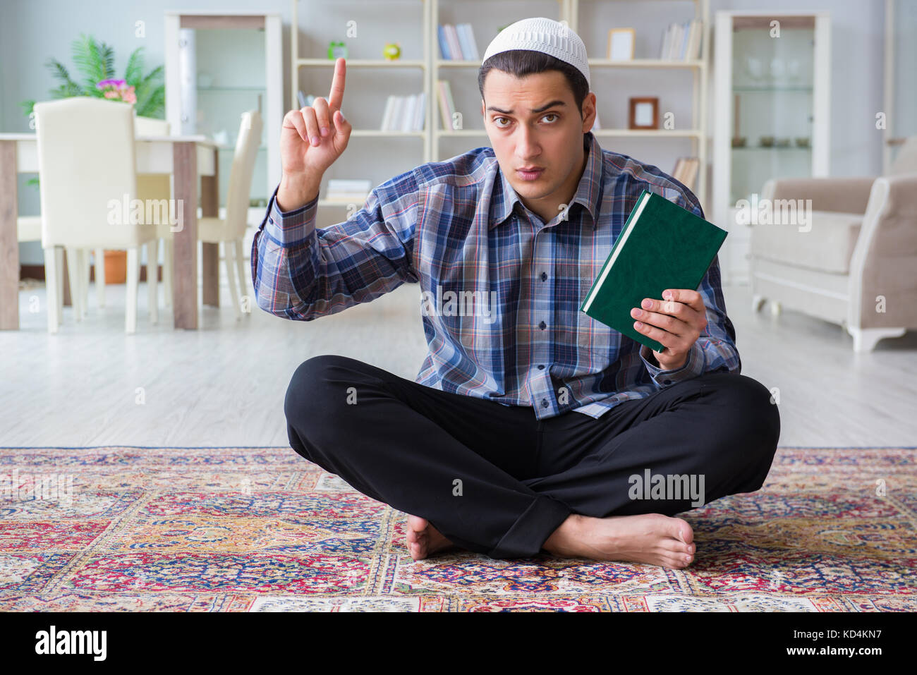 Young muslim man praying at home Stock Photo - Alamy