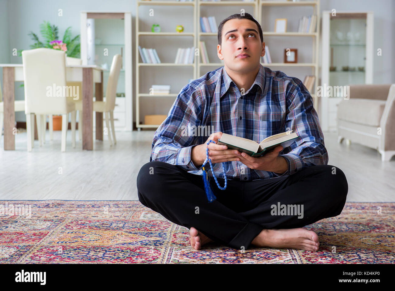 Young muslim man praying at home Stock Photo - Alamy